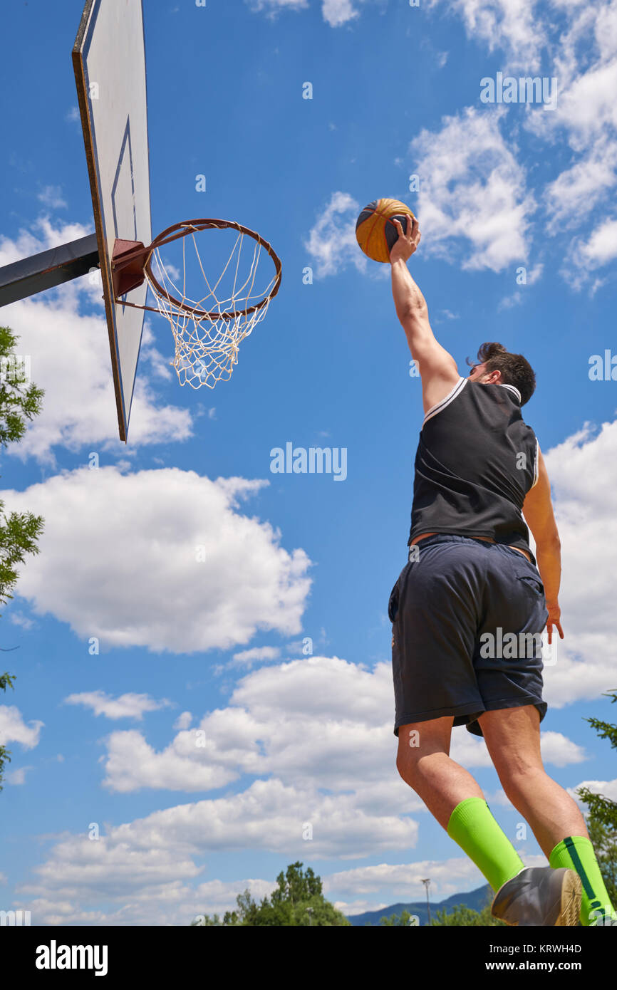 Basketball player in action flying high and scoring Stock Photo - Alamy