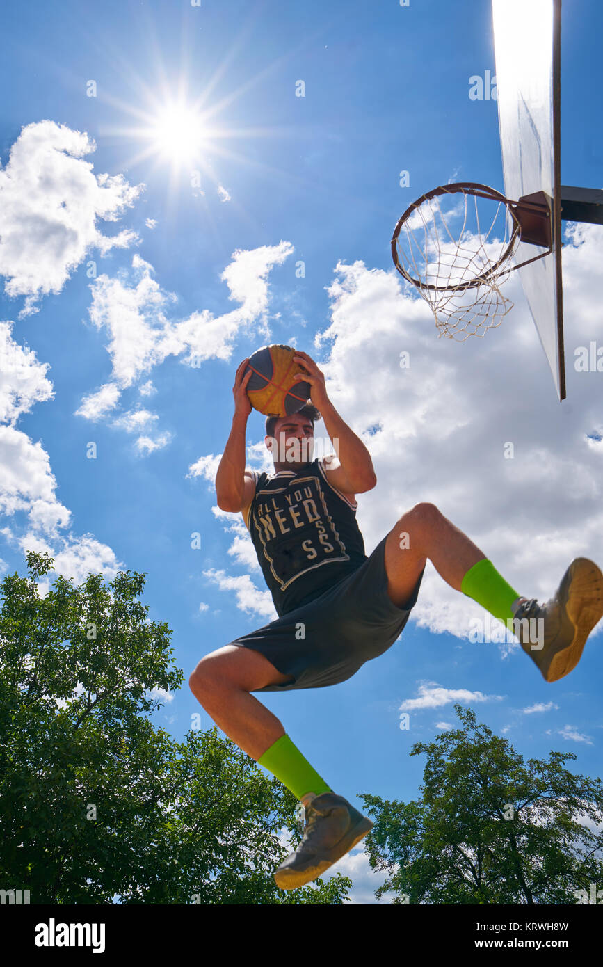 Basketball player in action flying high and scoring Stock Photo - Alamy
