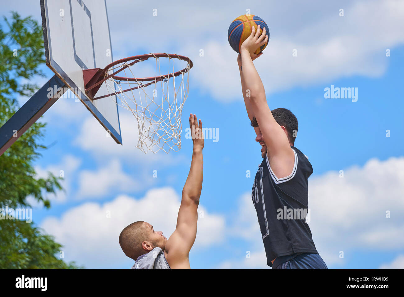 Basketball player in action flying high and scoring Stock Photo - Alamy