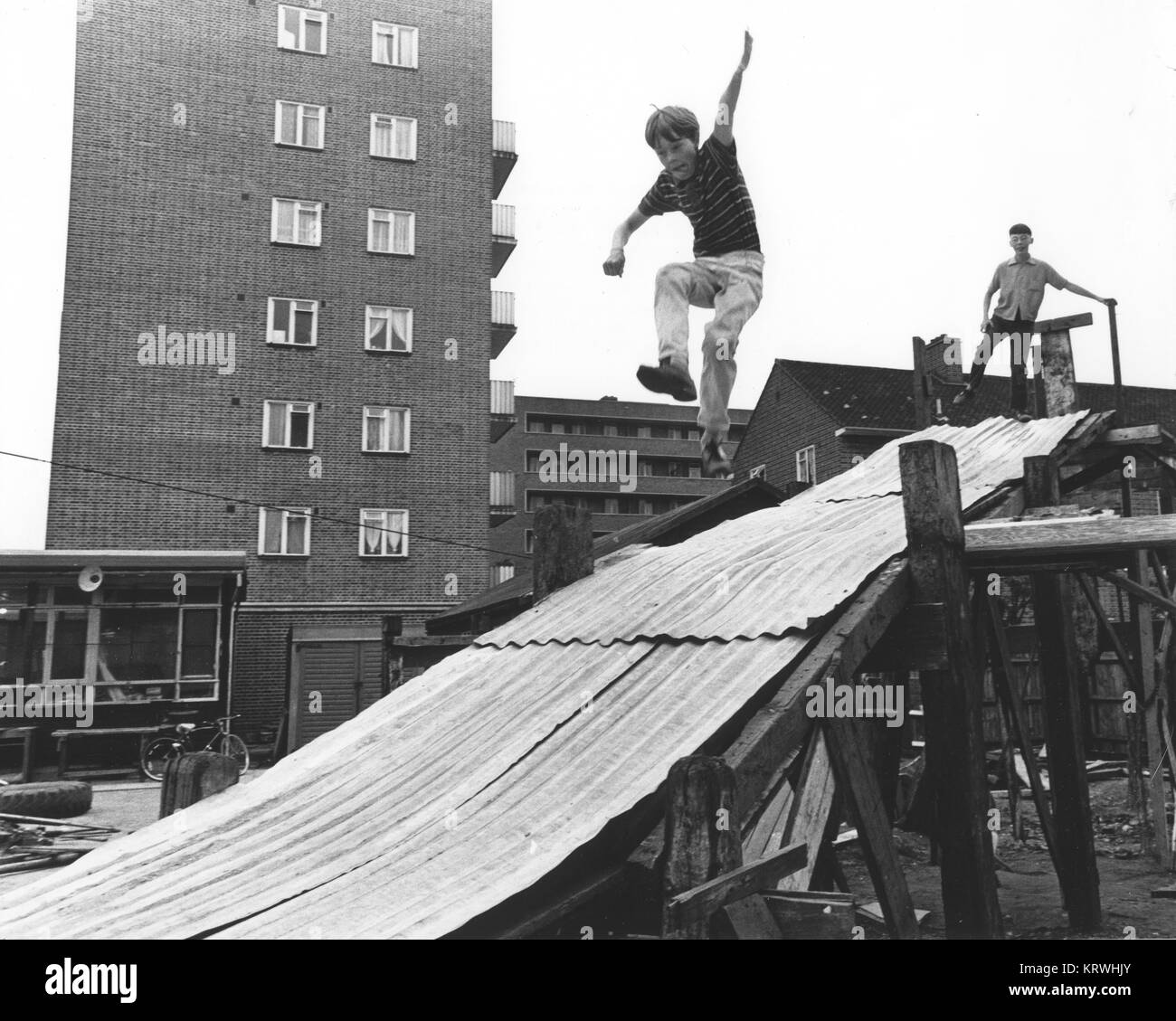 Boy plays on tin slide, England, Great Britain Stock Photo - Alamy