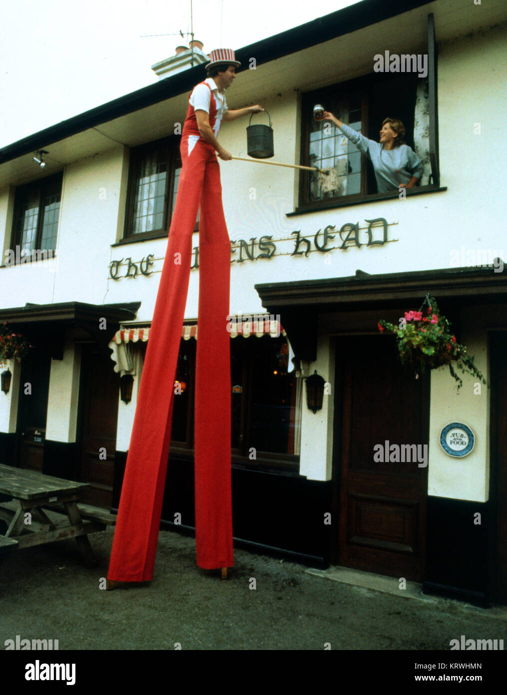 Man on stilts cleaning windows, England, Great Britain Stock Photo - Alamy