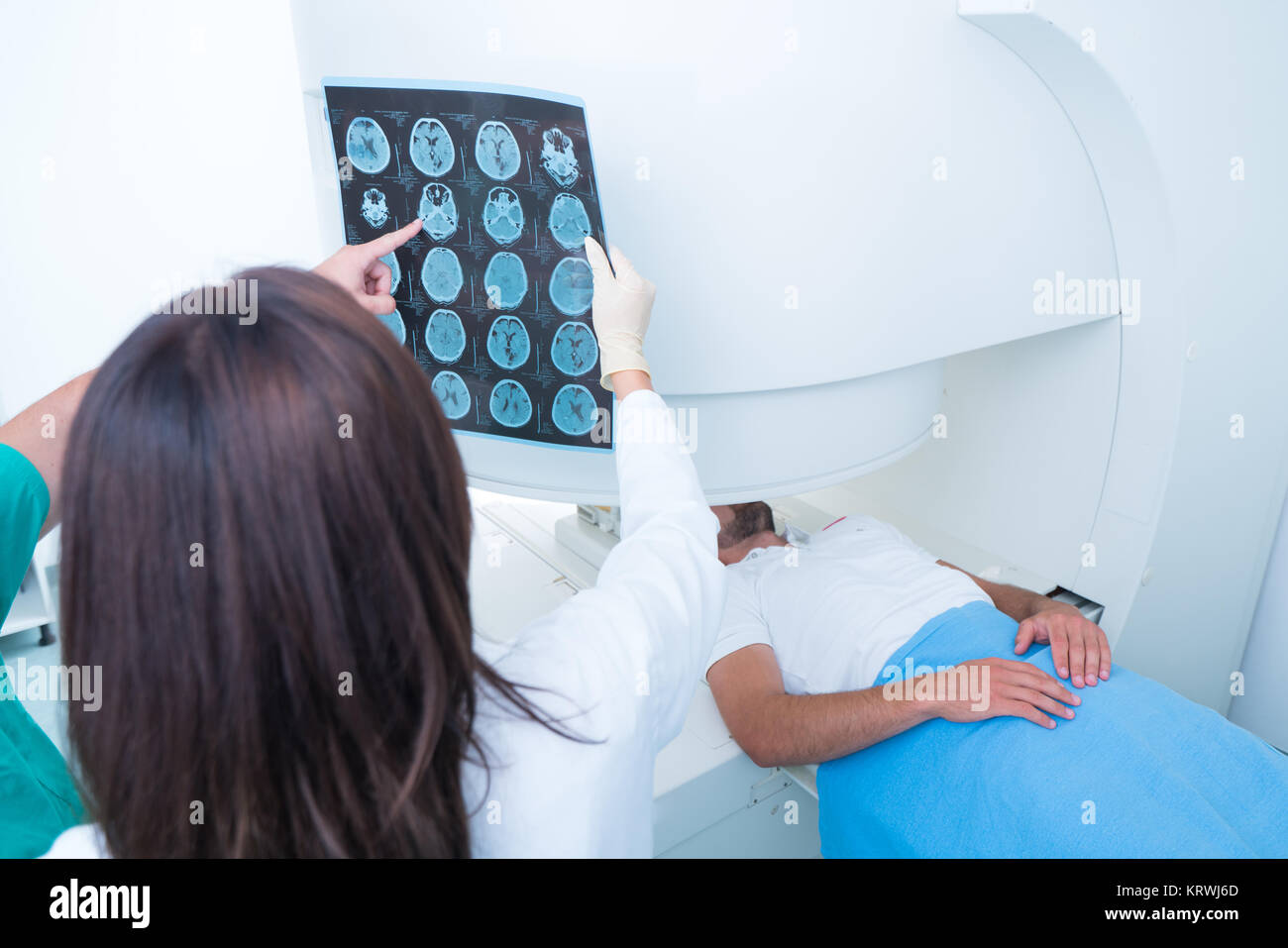 Confident pleasant doctor working with MRI scan results Stock Photo - Alamy