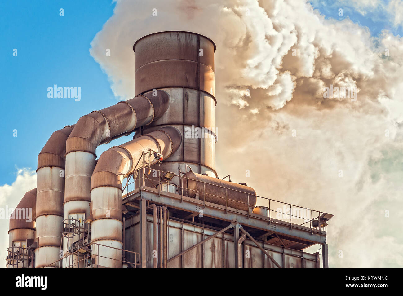 Old smokestack that emits smoke Stock Photo - Alamy