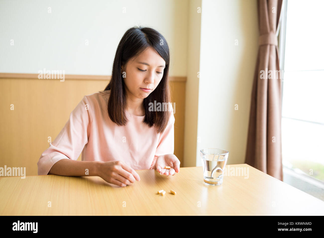 Woman take medicine at home Stock Photo - Alamy