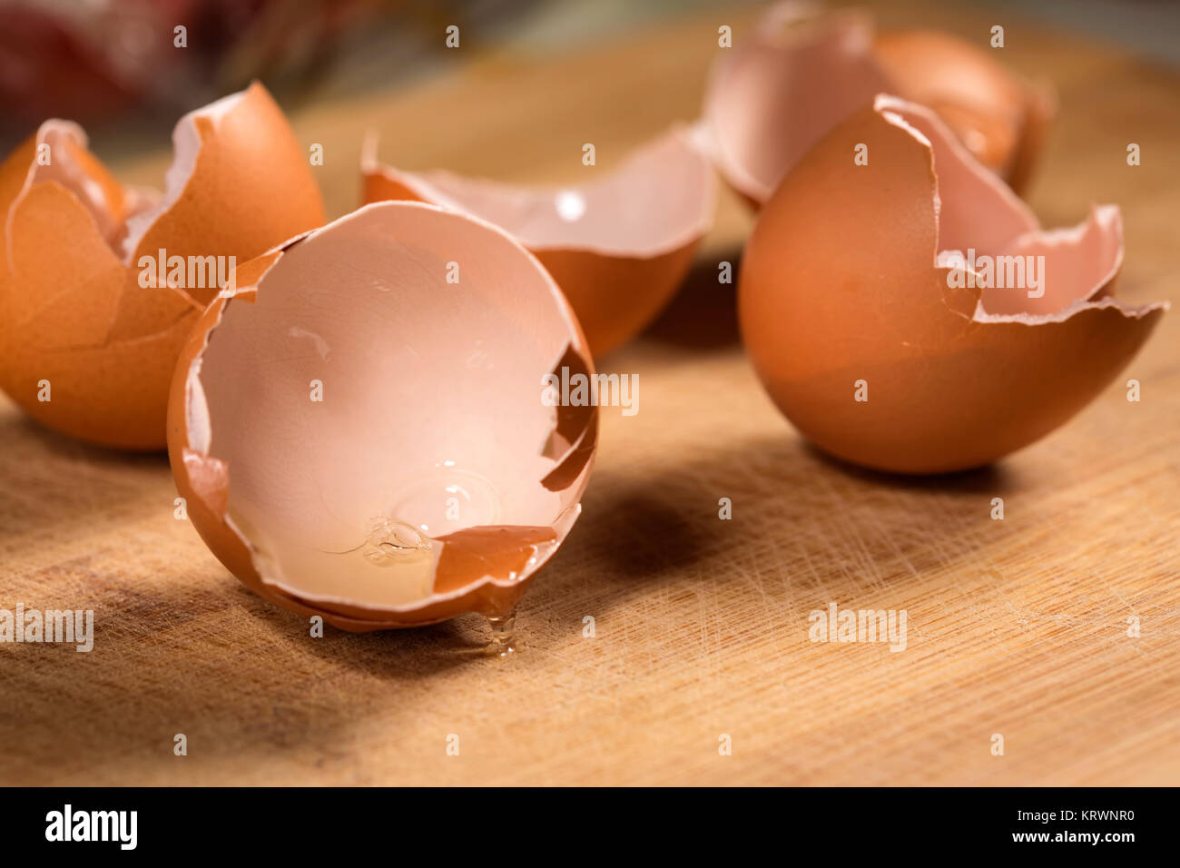 Close up of empty egg shells on wooden cutting board Stock Photo - Alamy