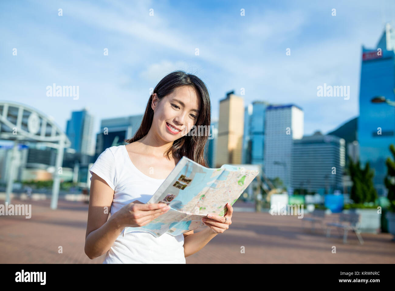 Woman reading on paper map Stock Photo - Alamy