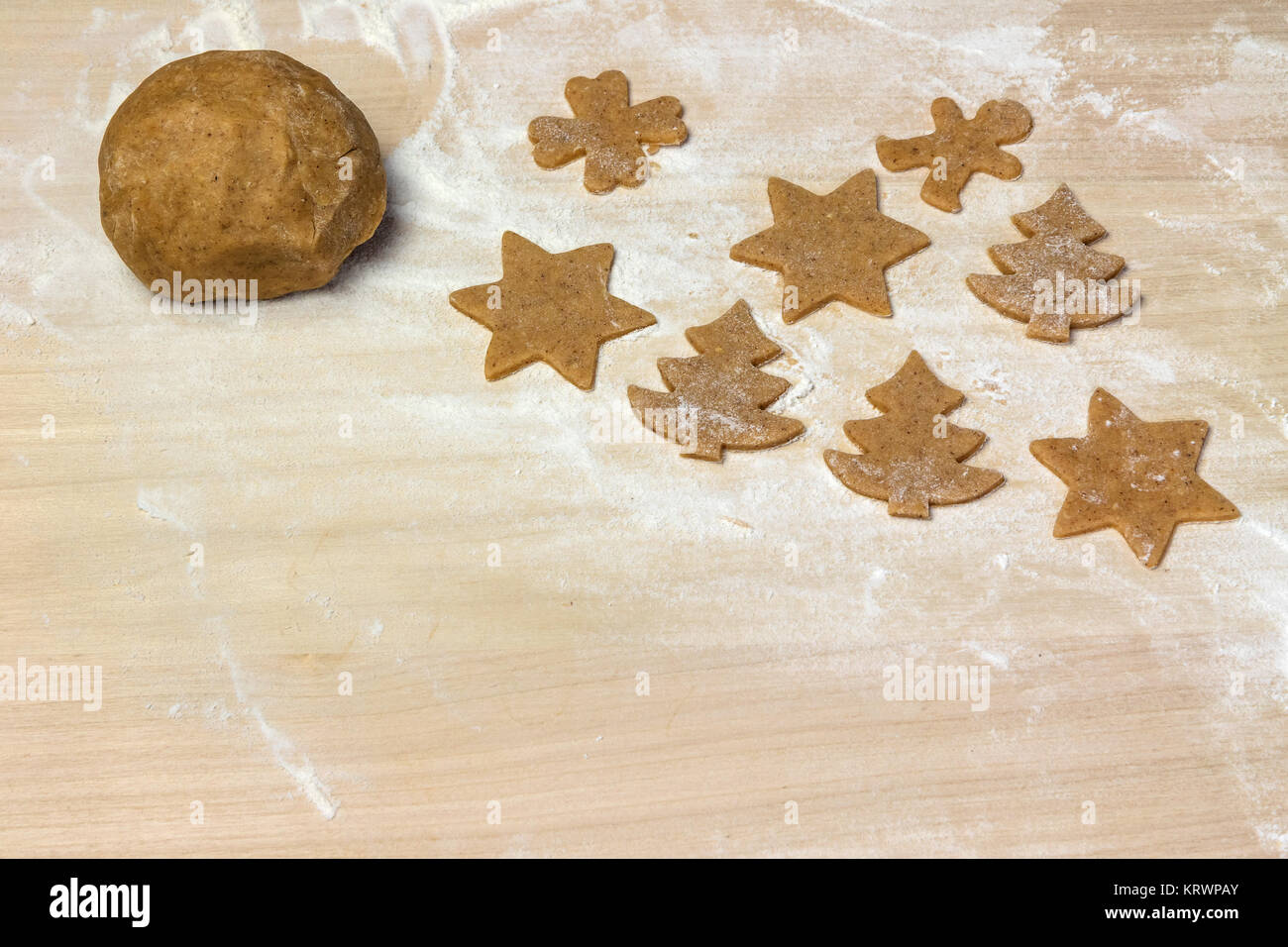 Cutted out shapes of cookies and ball of dough Stock Photo - Alamy