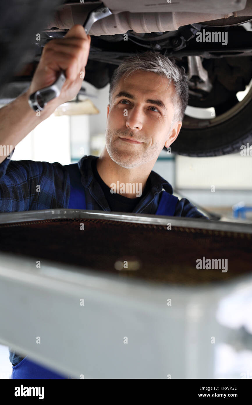 mechanic in the workshop. a car mechanic working in a workshop Stock ...