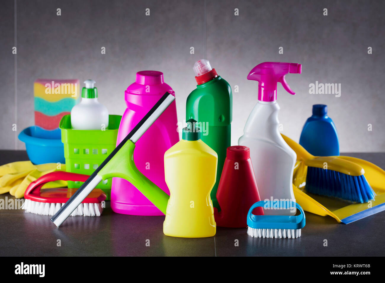 Colorful set of home cleaning products on the gray tiles. Place for ...