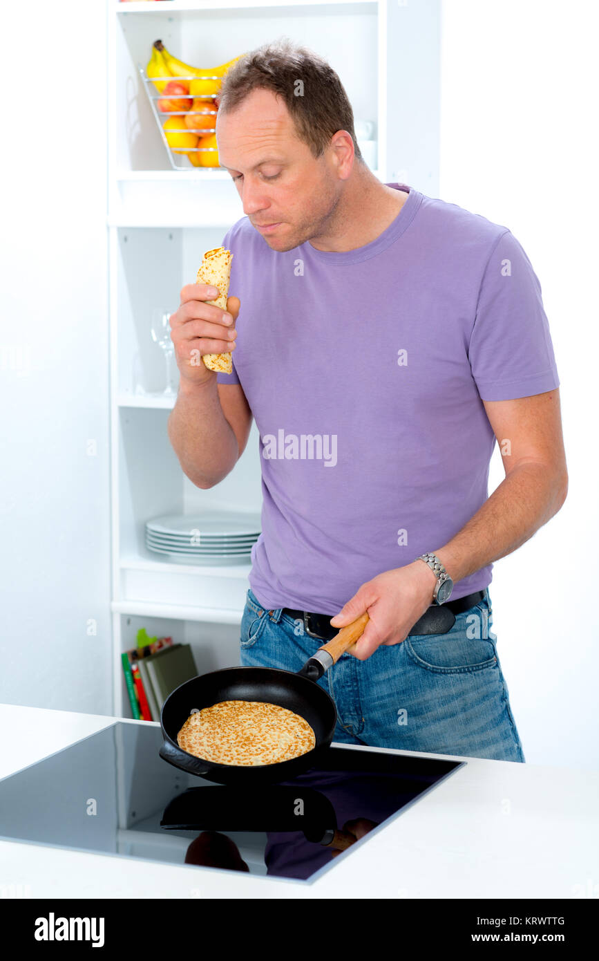 young man cooking pancake in the kitchen Stock Photo - Alamy