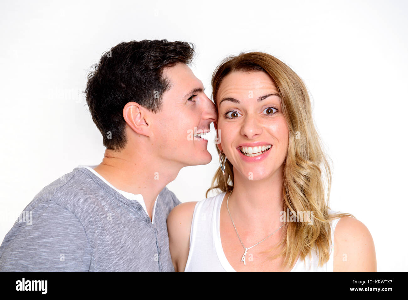 young man whisper in the ear of his girlfriend Stock Photo - Alamy