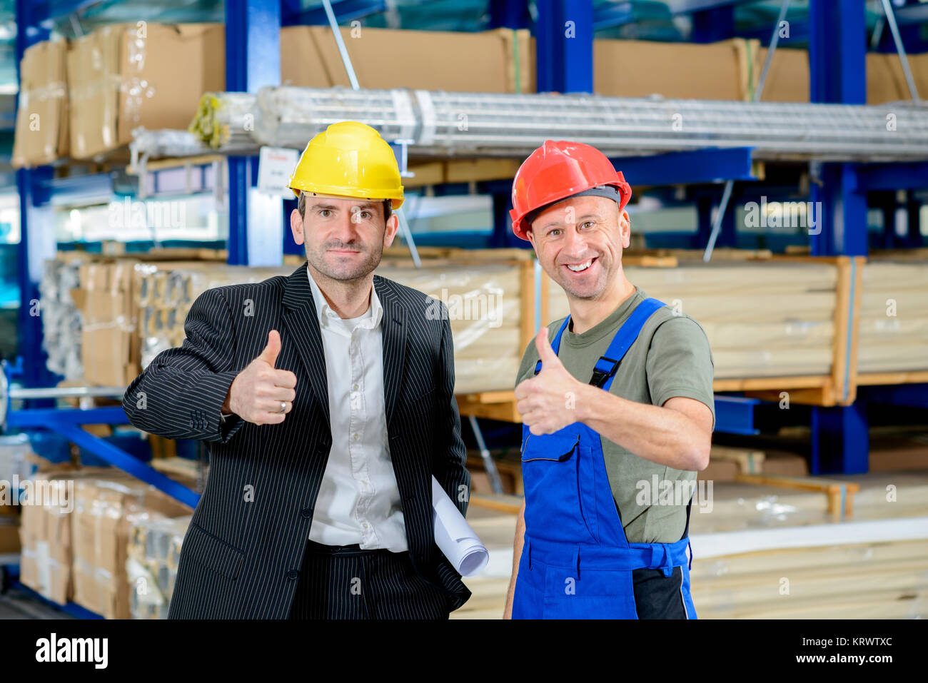 in the factory- young boss and worker with thumb up Stock Photo - Alamy