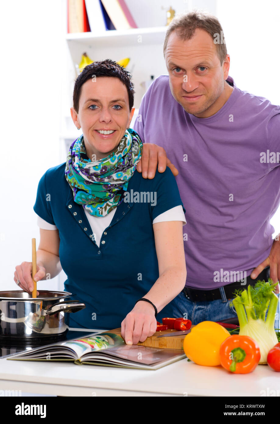 man and woman cooking together in the kitchen Stock Photo - Alamy