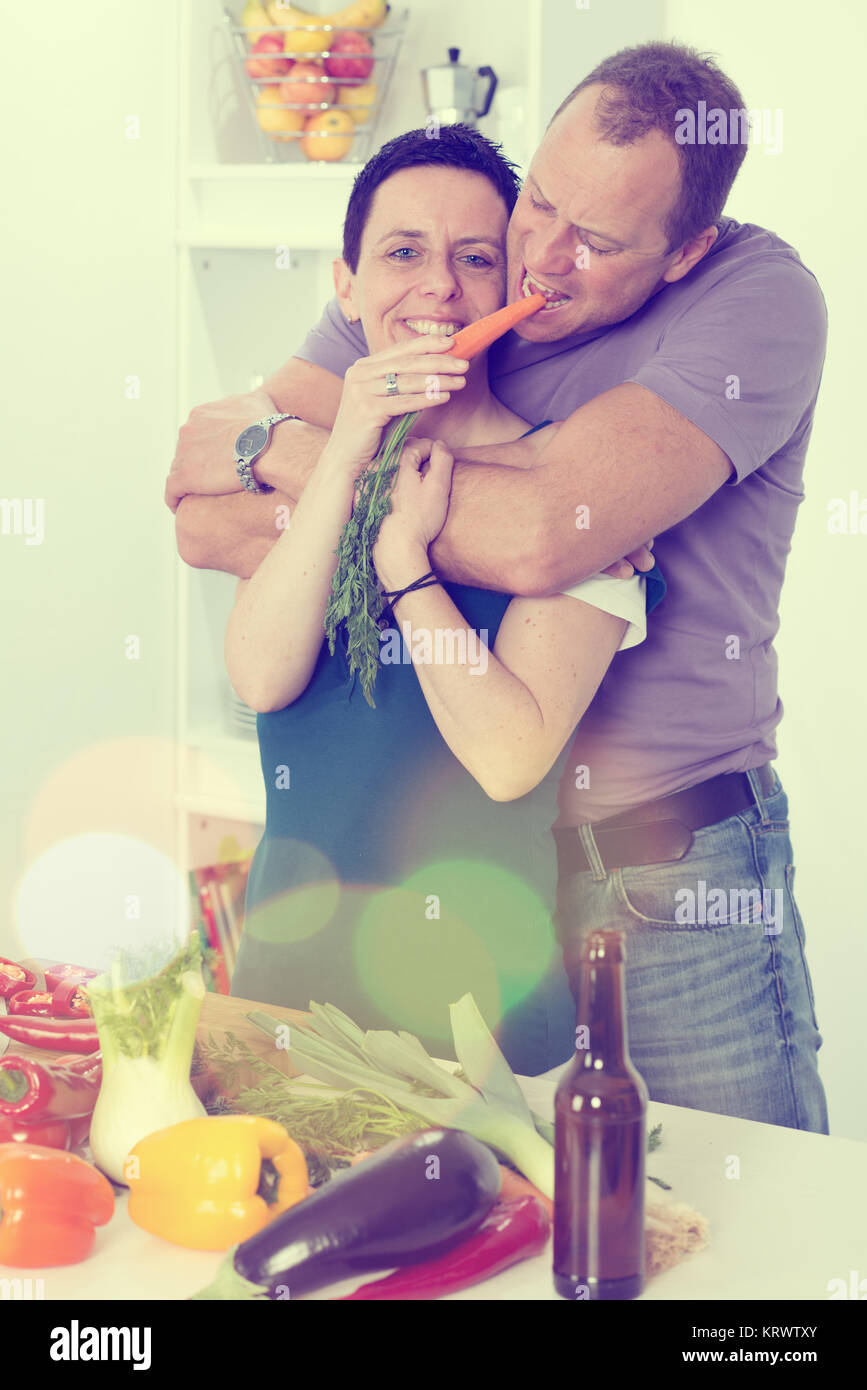 man and woman cooking together in the kitchen Stock Photo - Alamy