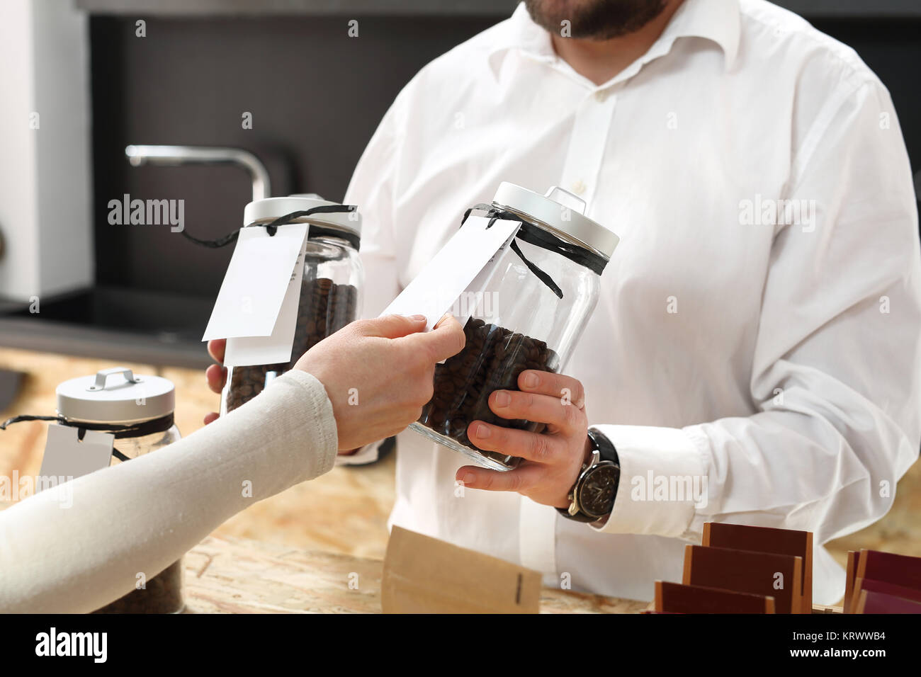a woman is buying coffee in a coffee shop Stock Photo - Alamy