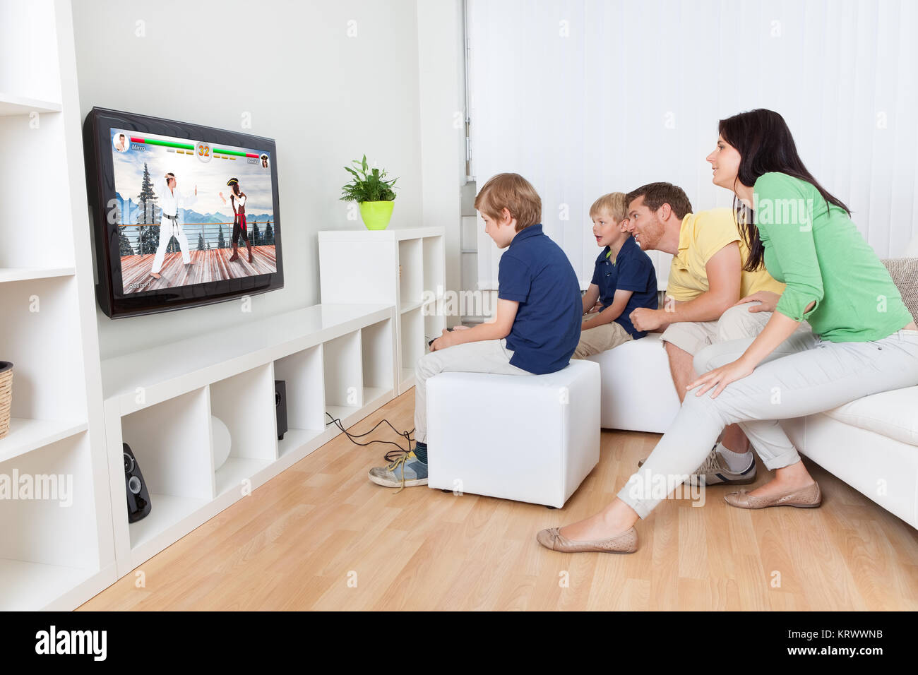 Young family playing videogames Stock Photo - Alamy