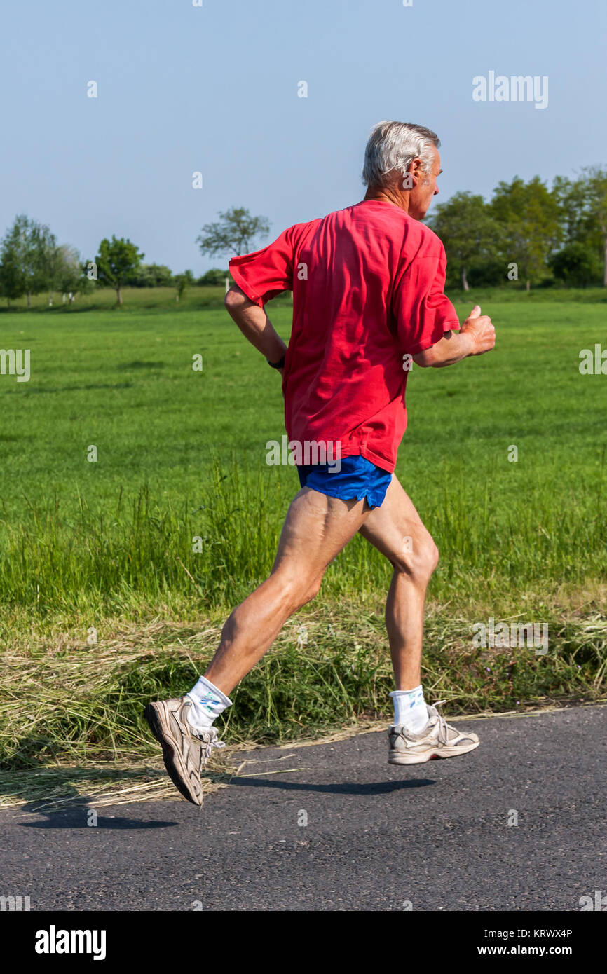 Senior runner while training for a competition Stock Photo - Alamy