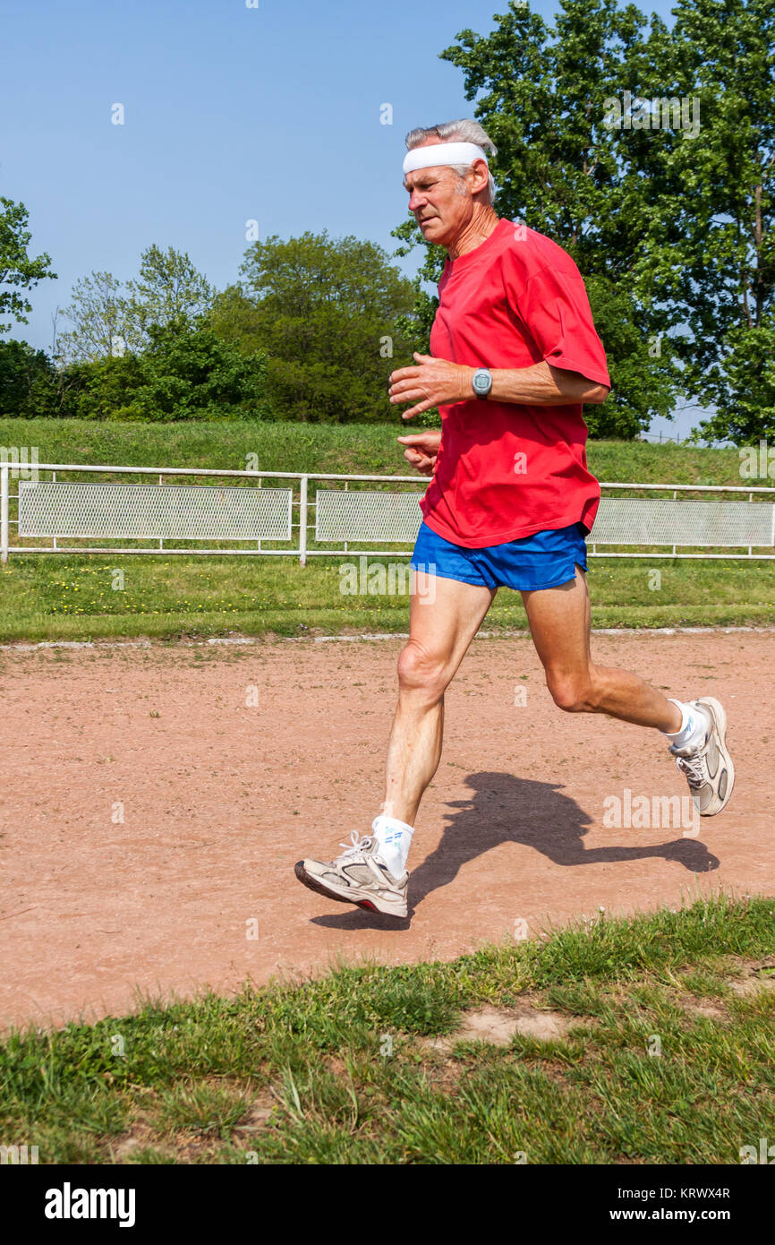 Senior runner while training for a competition Stock Photo - Alamy