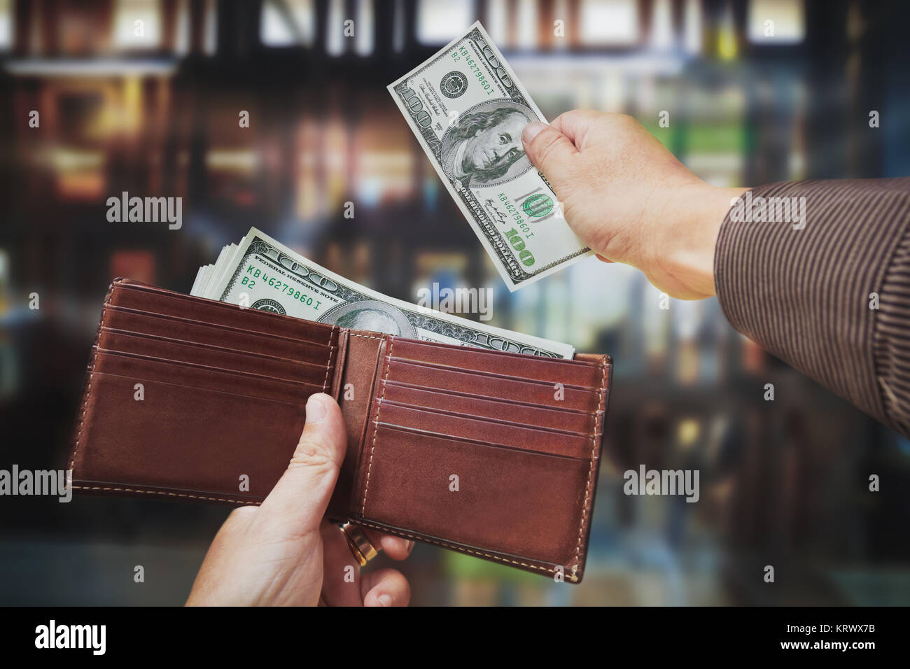 Isolated of hands taking out cash to spend Stock Photo - Alamy