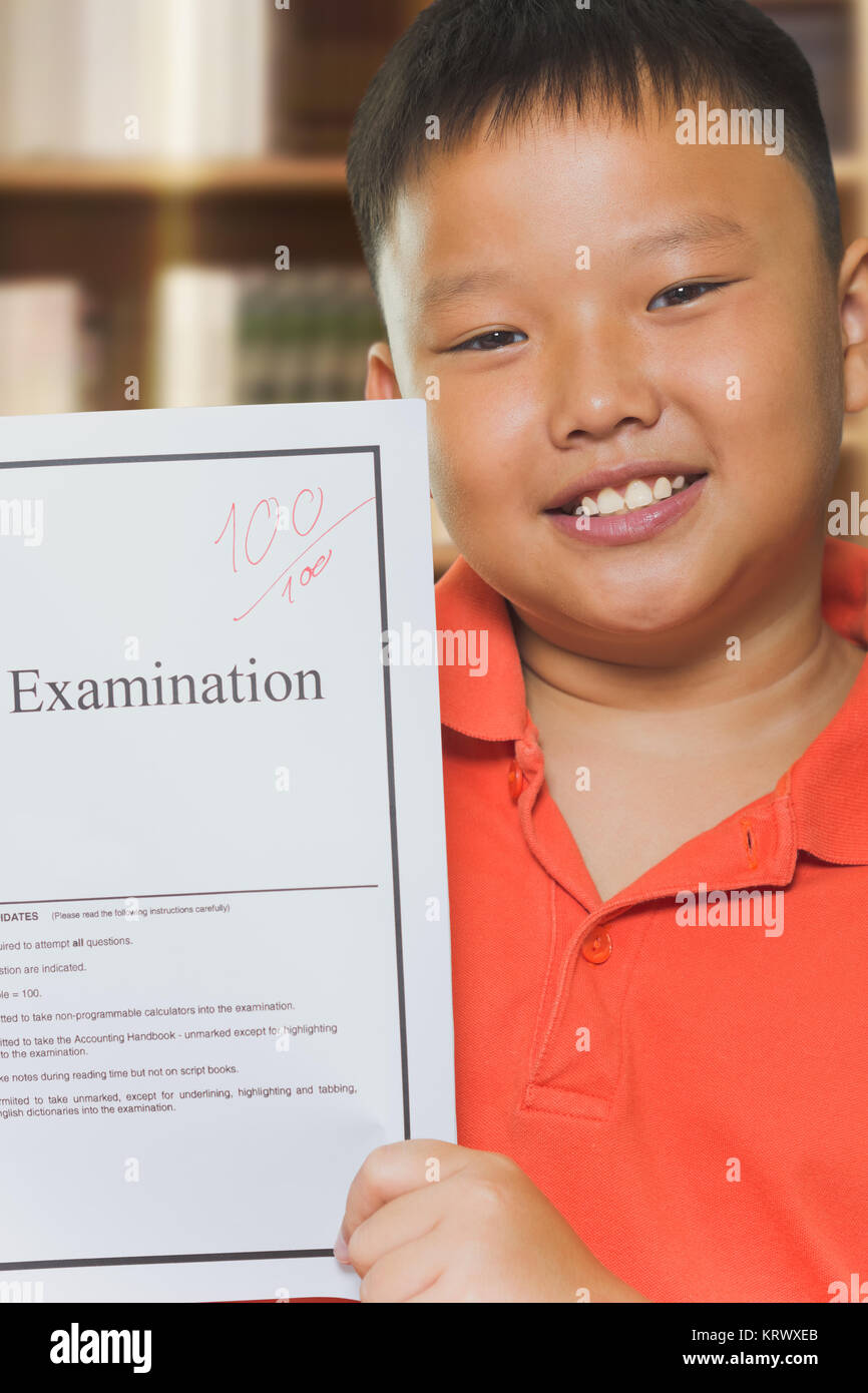 Young asian boy with full score examination sheets Stock Photo - Alamy