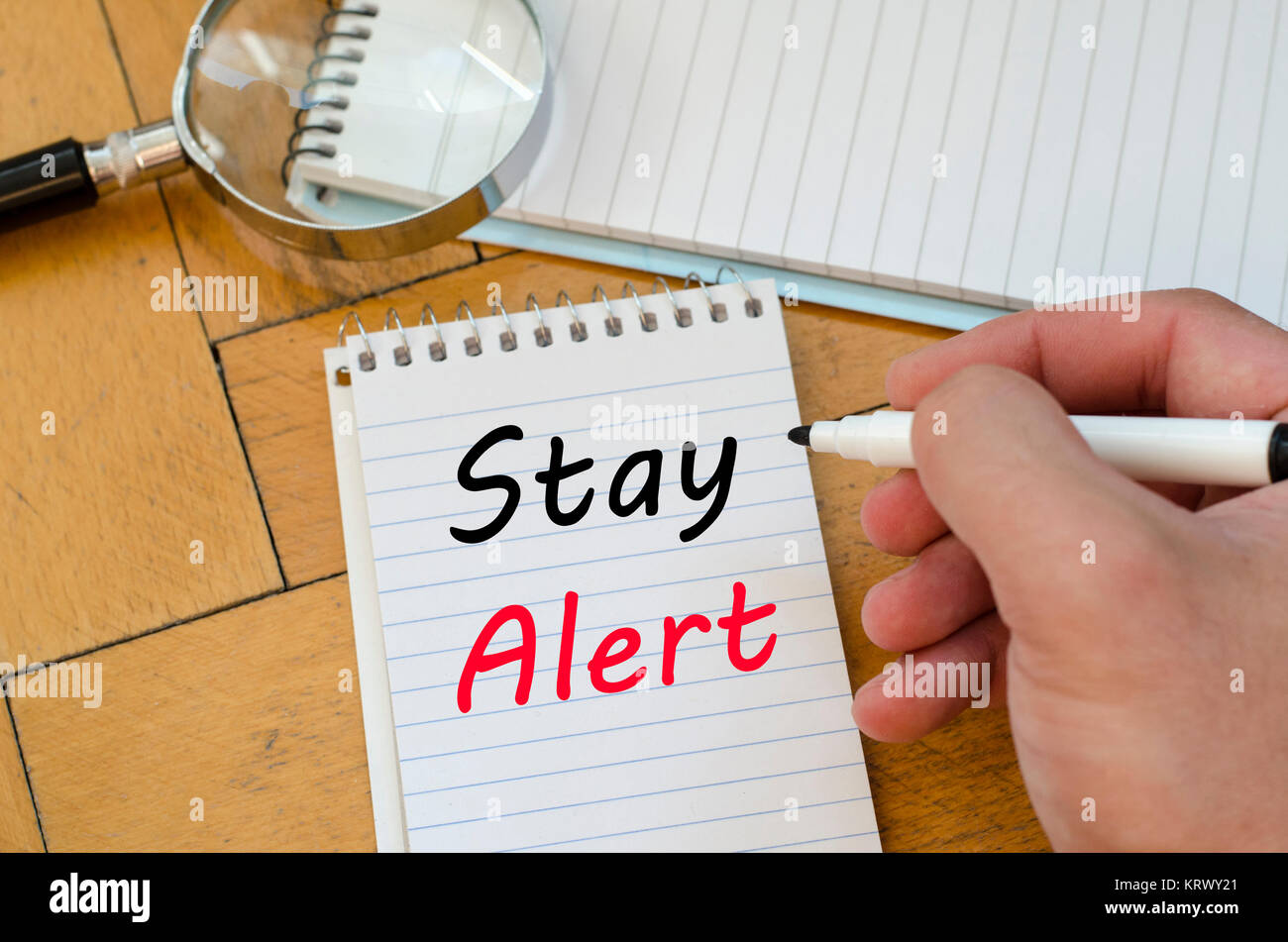 Stay alert concept on notebook Stock Photo - Alamy