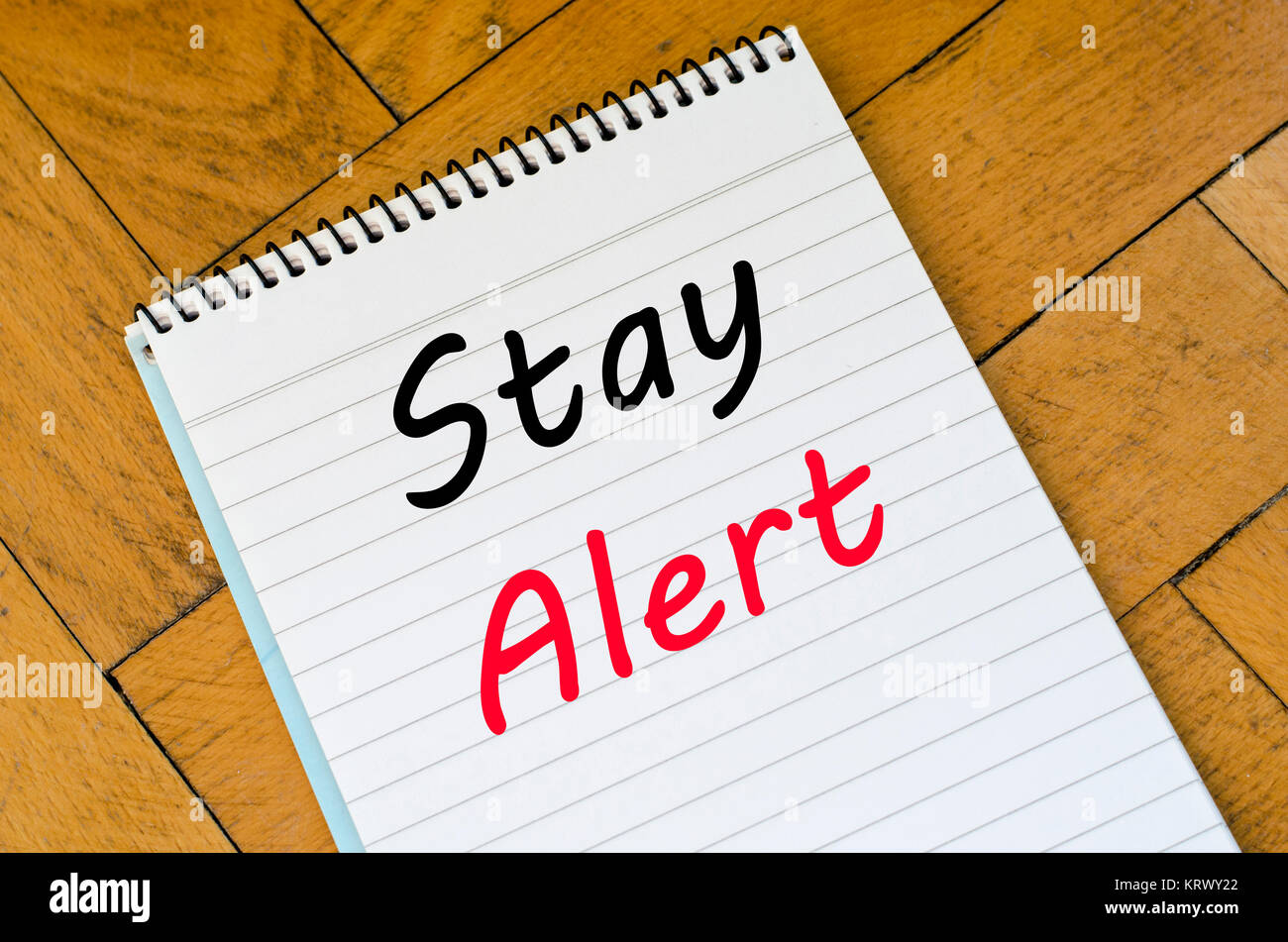Stay alert concept on notebook Stock Photo - Alamy