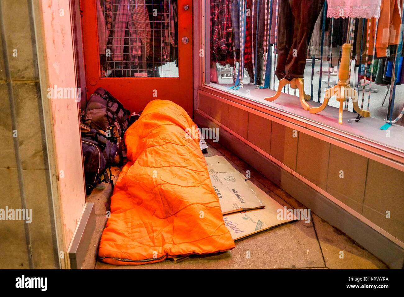 Homeless person in sleeping bag sleeping in storefront. State Steet ...