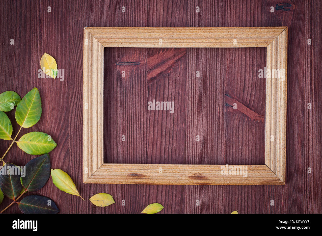 Empty wooden frame on brown wooden surface Stock Photo - Alamy