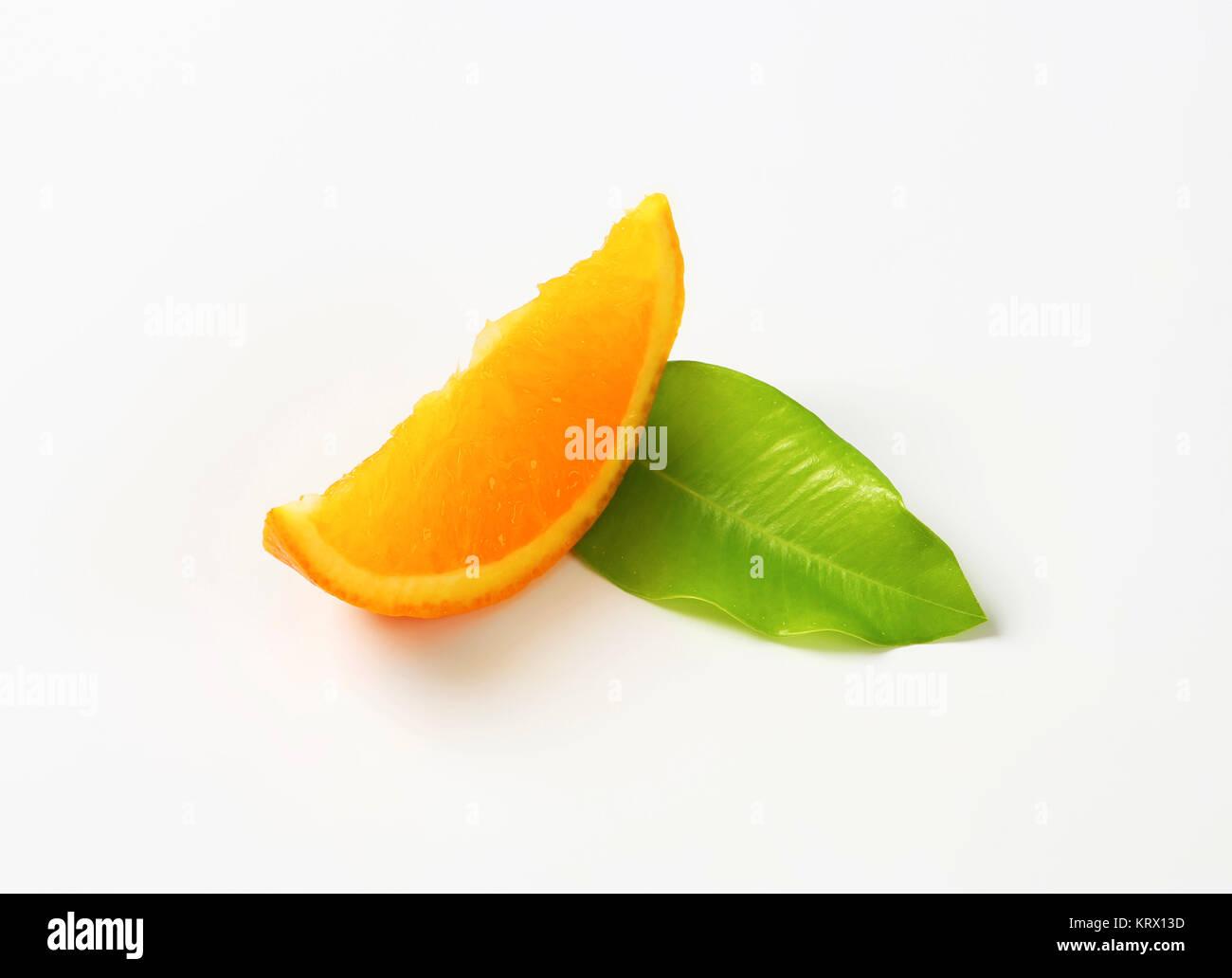 Single orange wedge Stock Photo - Alamy