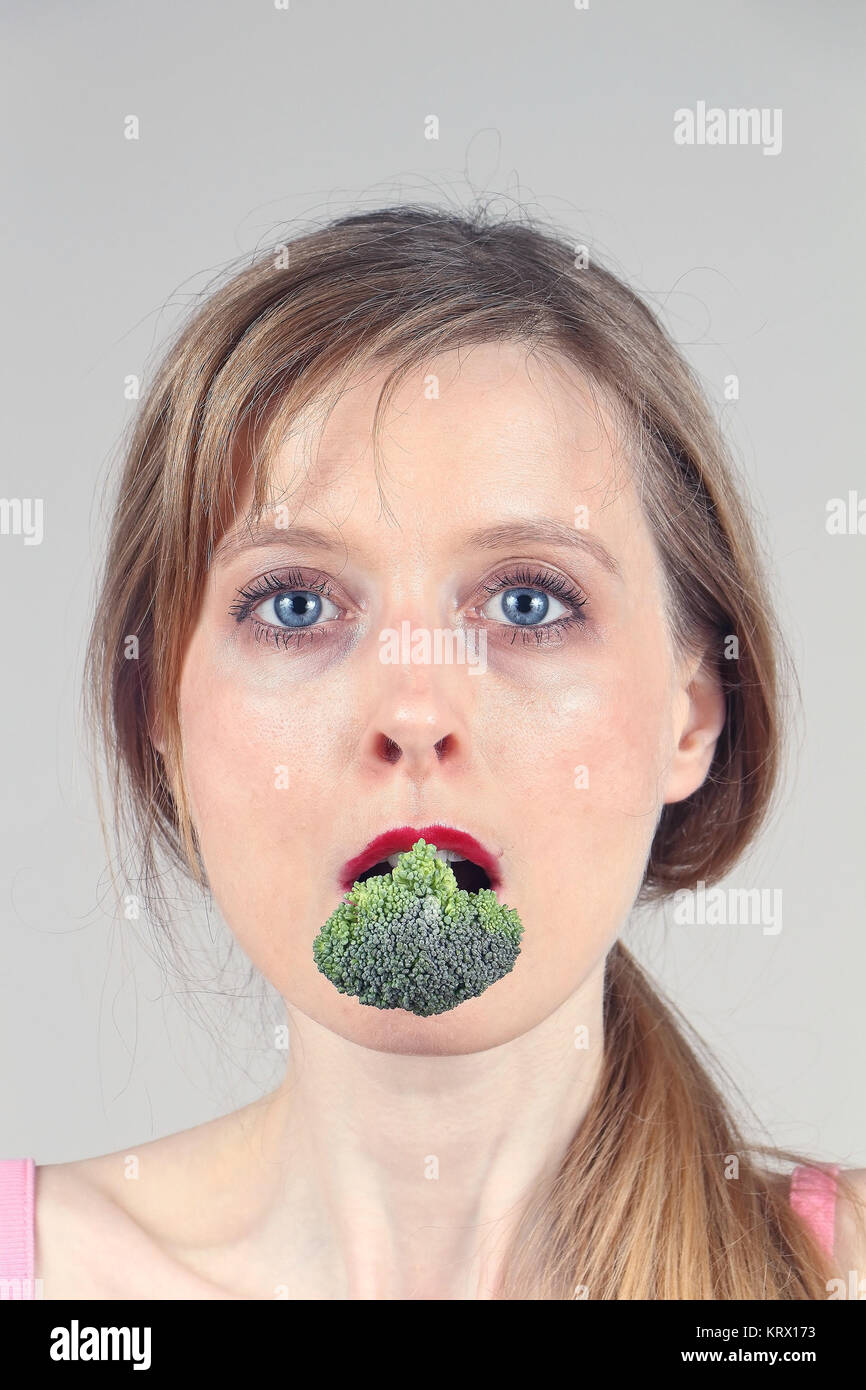Broccoli inside mouth Stock Photo - Alamy