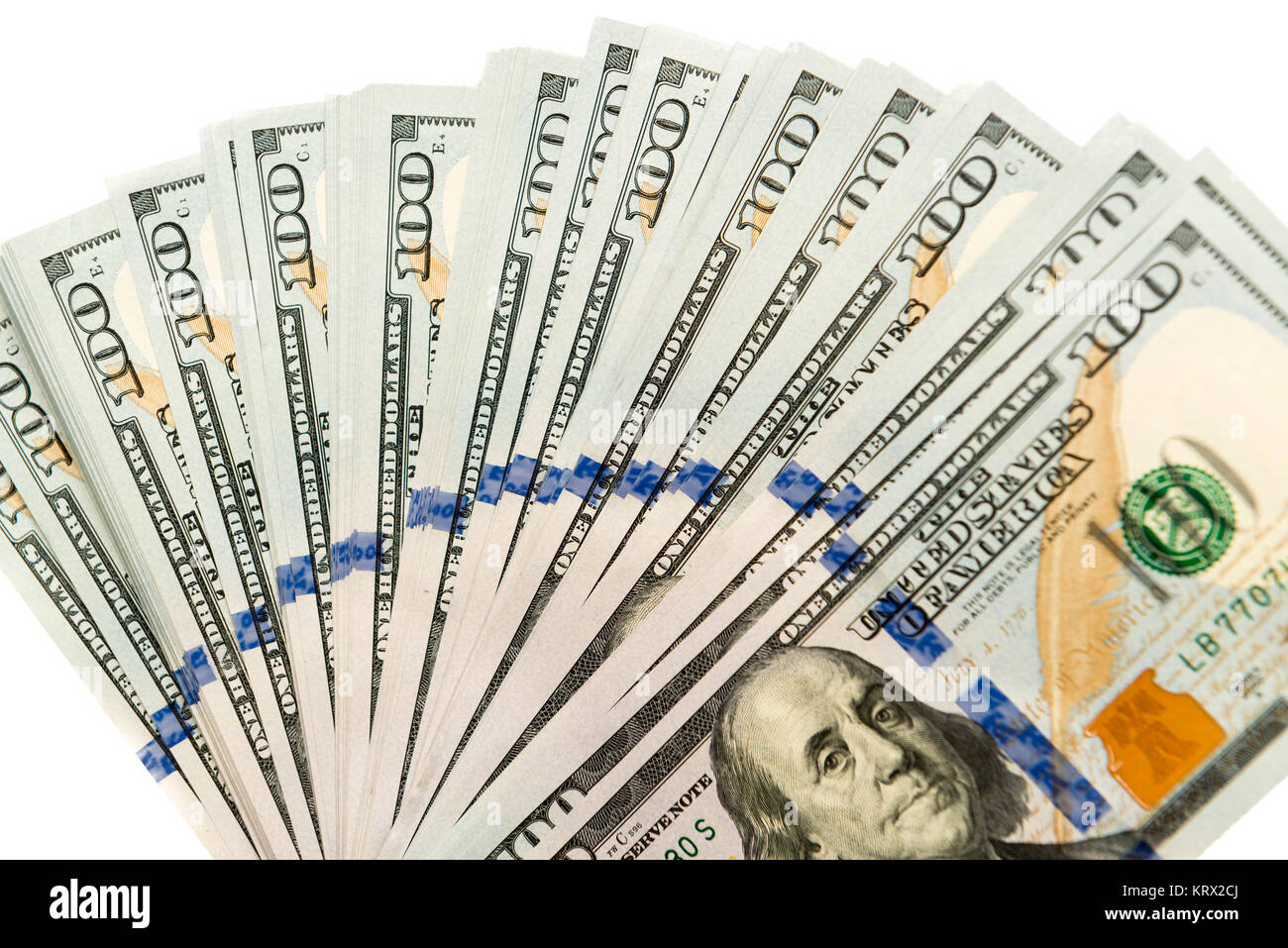 Many hundred dollar banknotes spread on white surface Stock Photo - Alamy
