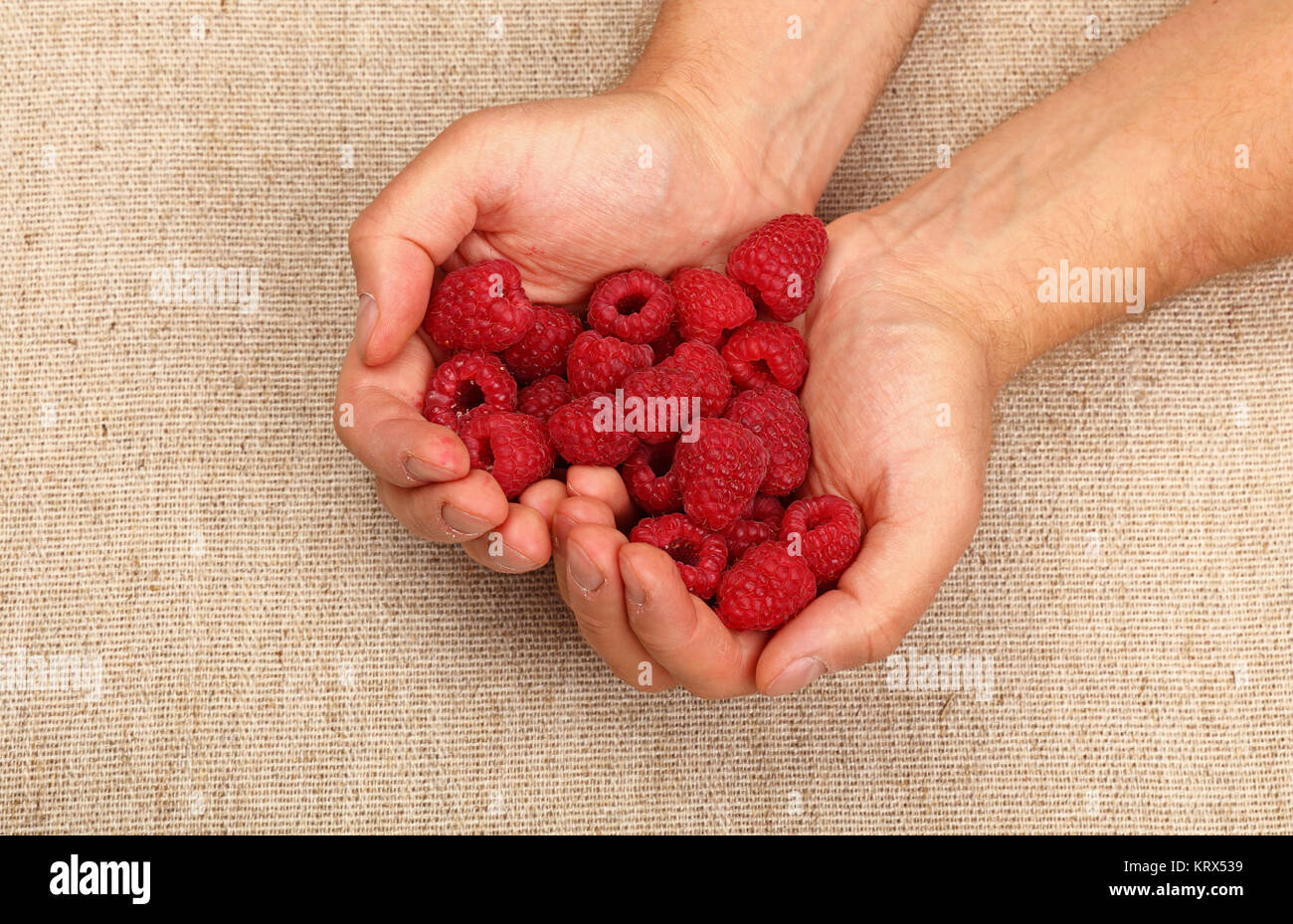 Man hands with heart shaped raspberries Stock Photo - Alamy
