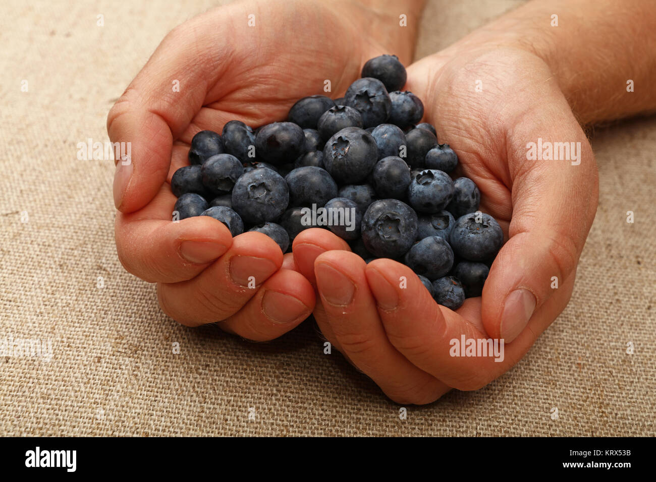 Man hands with heart shaped blueberries Stock Photo - Alamy