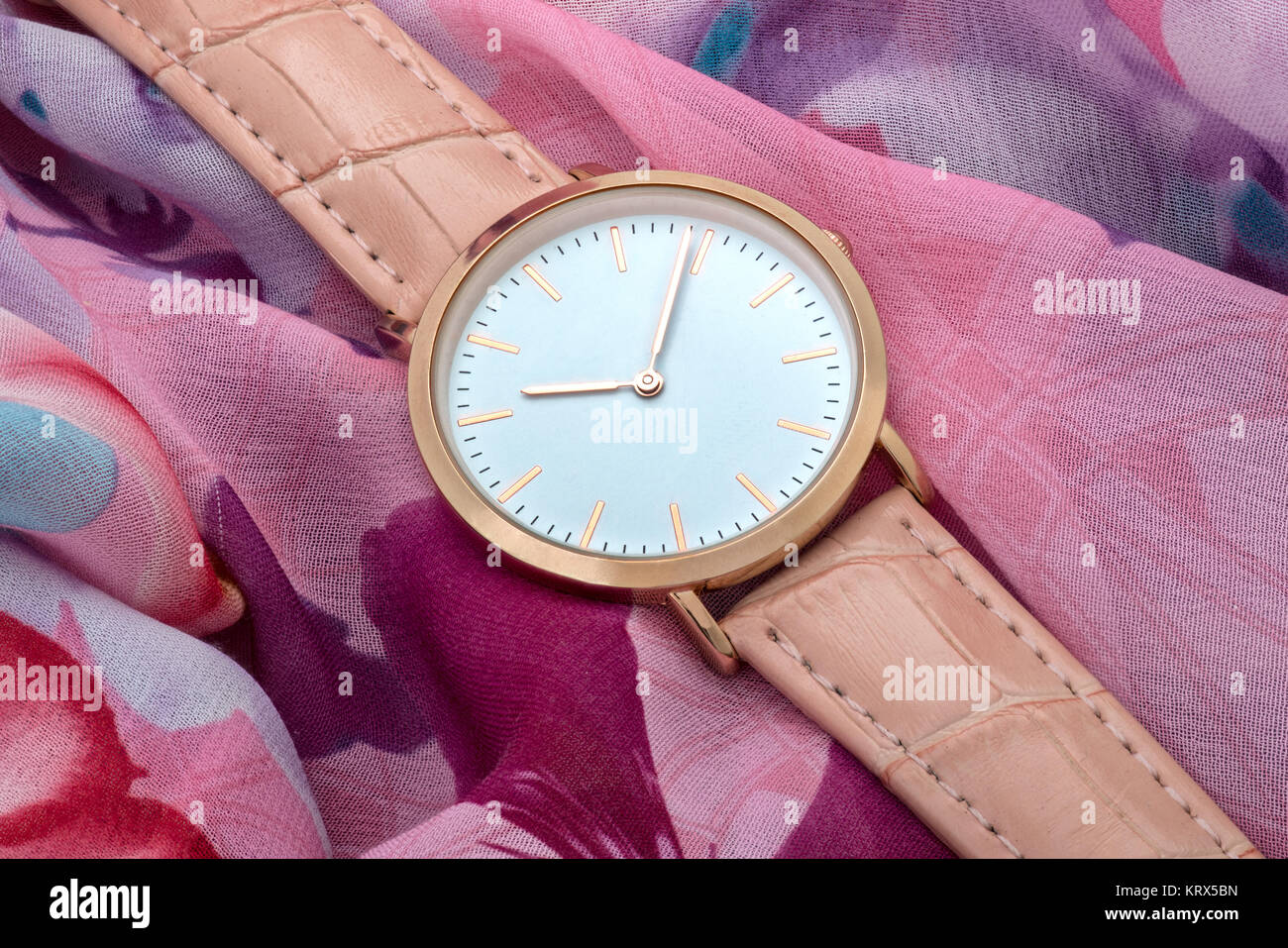 Wrist watch on colourful silk fabric background Stock Photo - Alamy