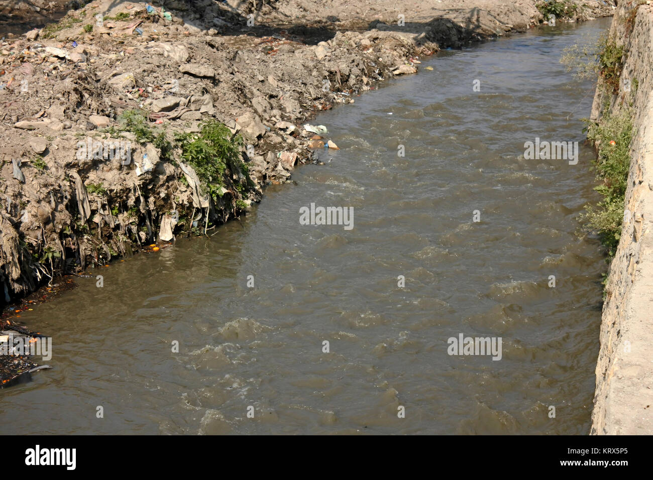 Mounts of plastic bags, dust and build up over many years in a river ...