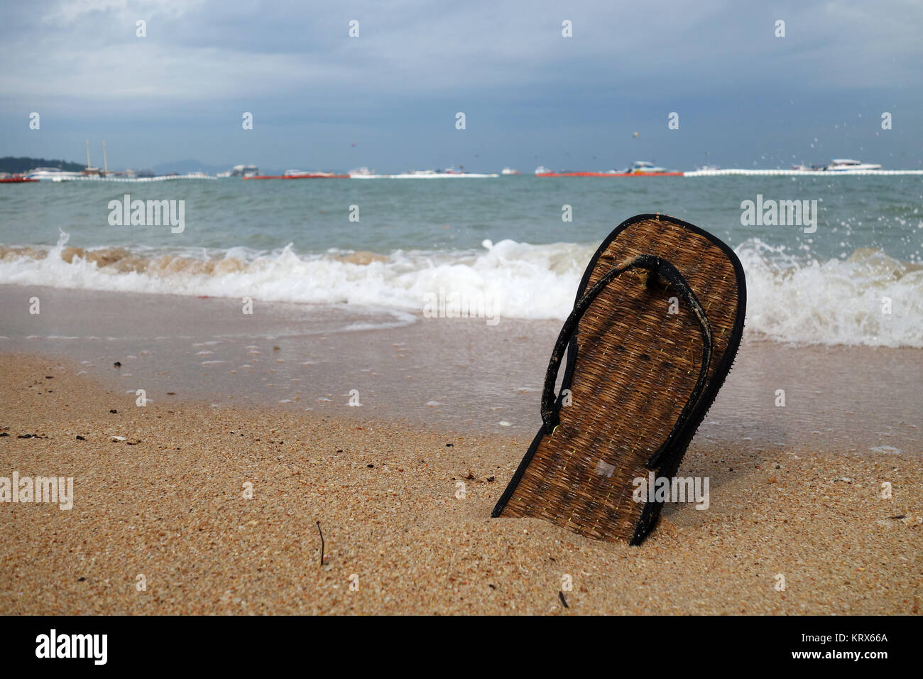 Beach slippers on a sandy beach Stock Photo - Alamy