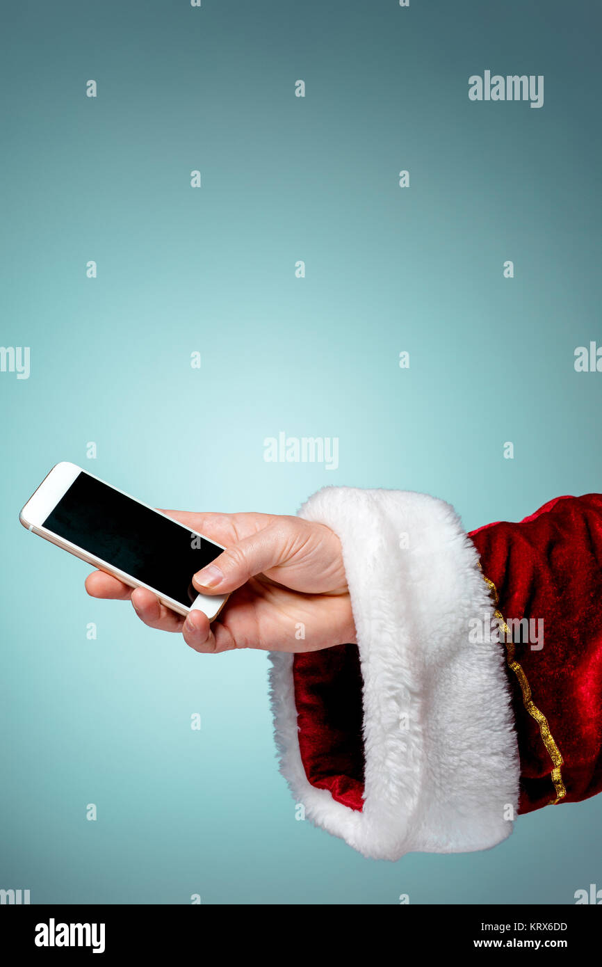 Santa Claus holding mobile smartphone ready for Christmas time Stock ...