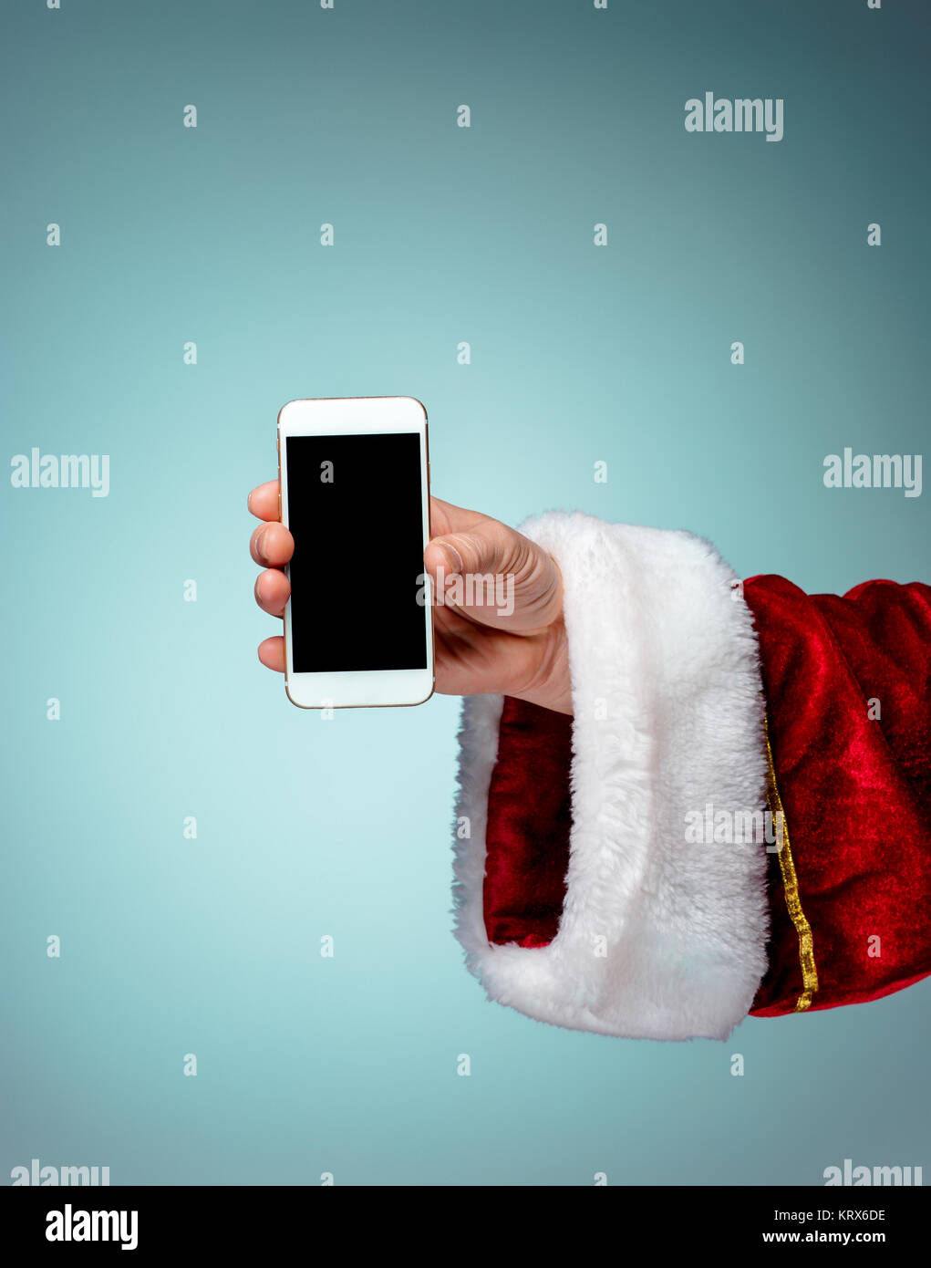 Santa Claus holding mobile smartphone ready for Christmas time Stock ...
