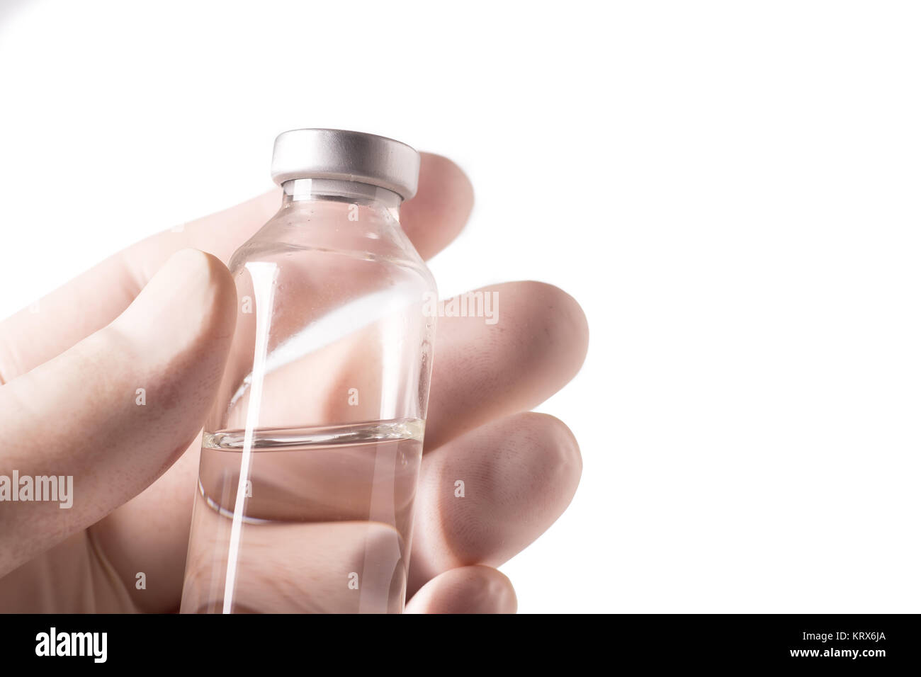 Hand with protective glove holding the vial Stock Photo - Alamy