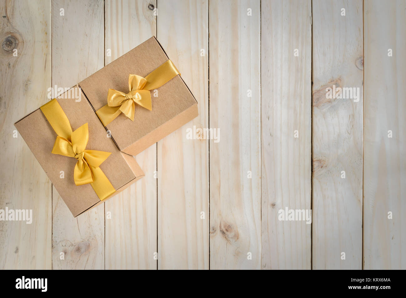 Brown gift boxes with gold bow Stock Photo - Alamy