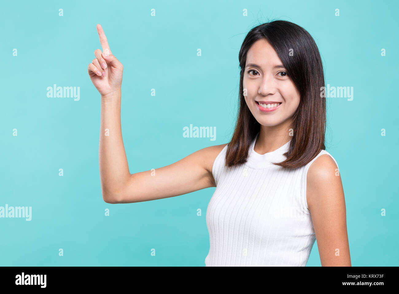 Young woman showing finger up Stock Photo - Alamy