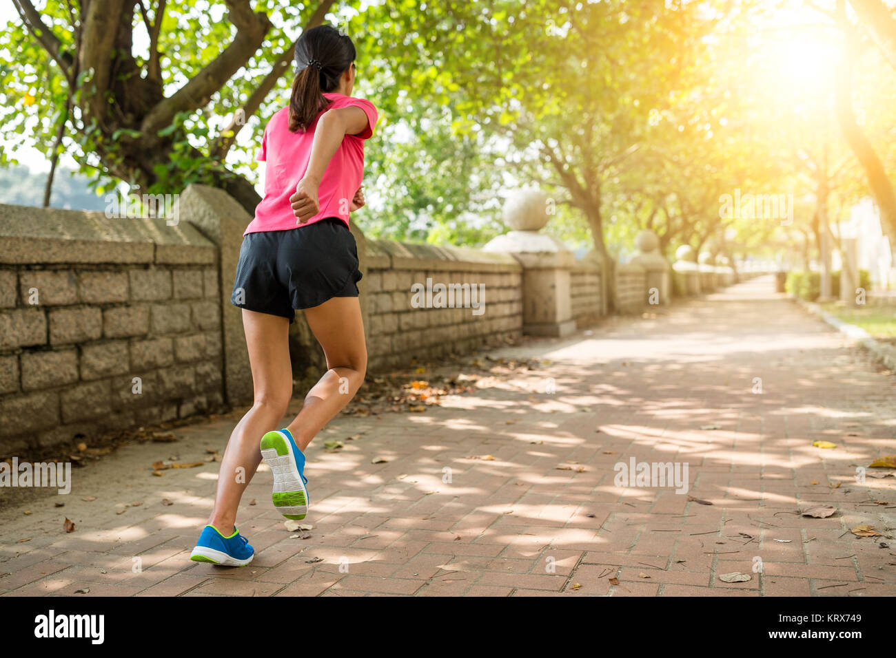 Woman run in a park Stock Photo - Alamy