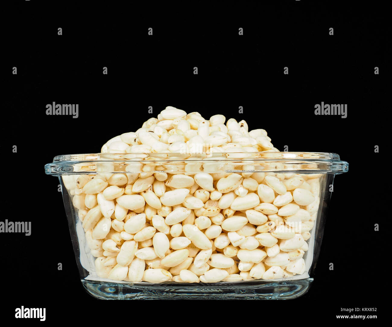 Puffed rice in translucent square glass bowl, towards black Stock Photo ...
