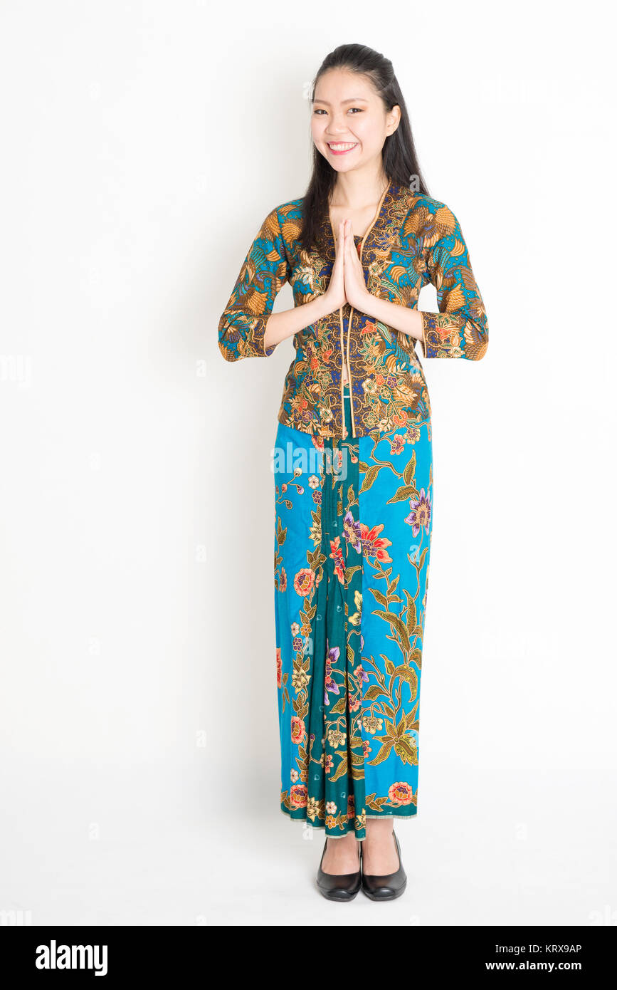 Southeast Asian woman in batik dress greeting Stock Photo - Alamy