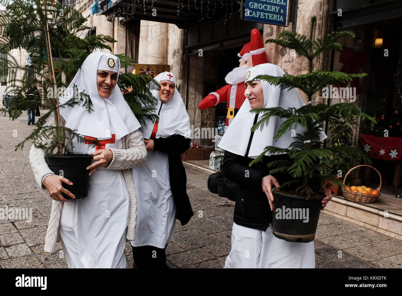 Jerusalem, Israel. 21st December, 2017. Nuns pickup Christmas trees ...