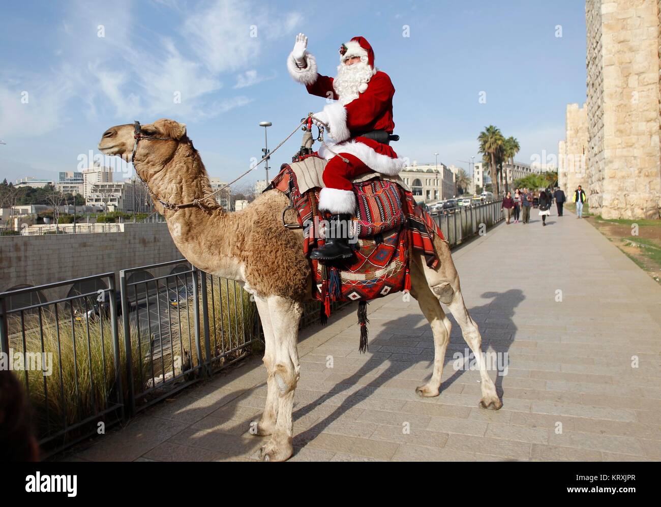 Jerusalem. 21st Dec, 2017. A man dressed as Santa Claus rides a camel ...