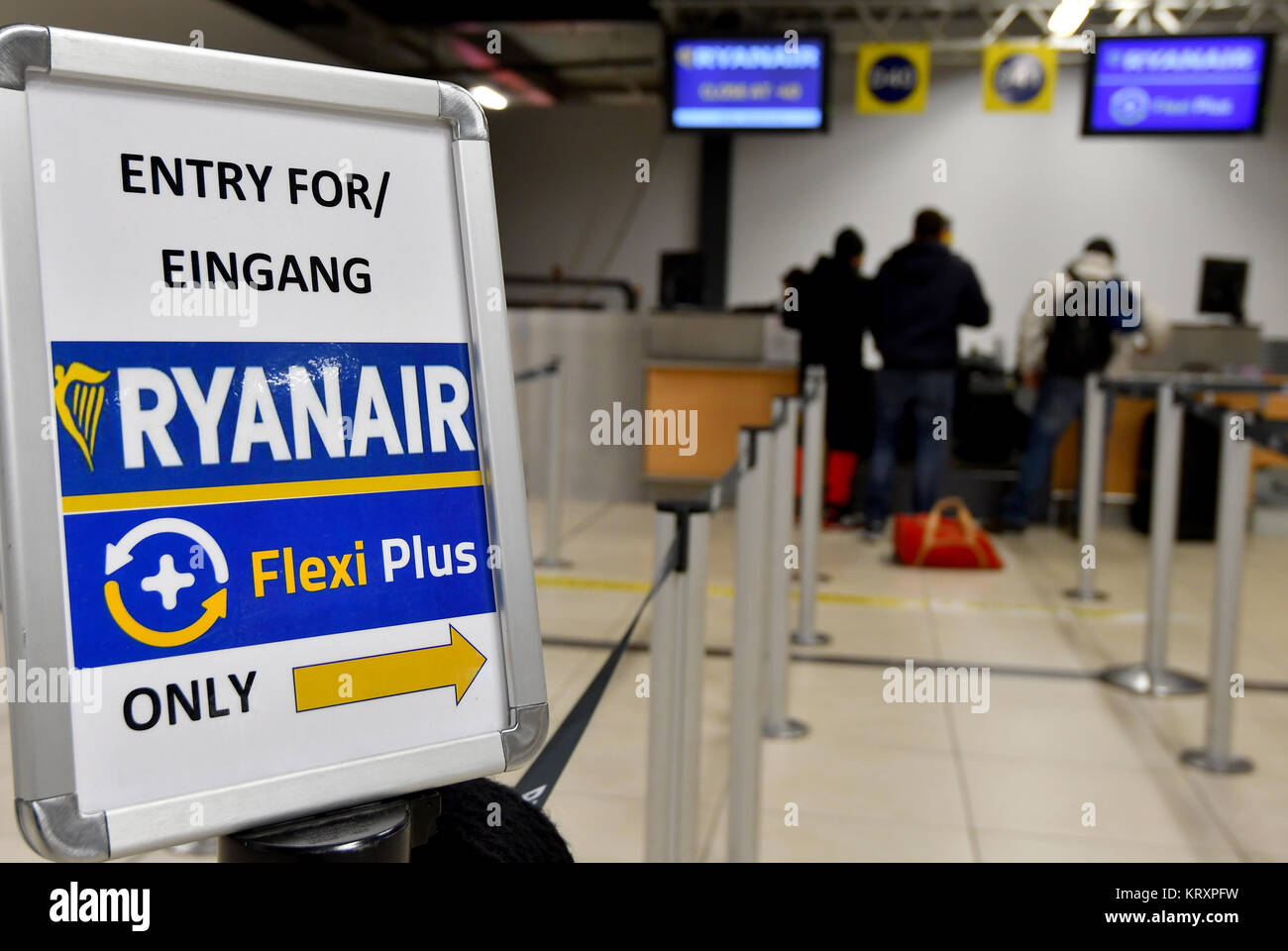 Passengers stand at the Ryanair check-in counter at the airport Berlin ...