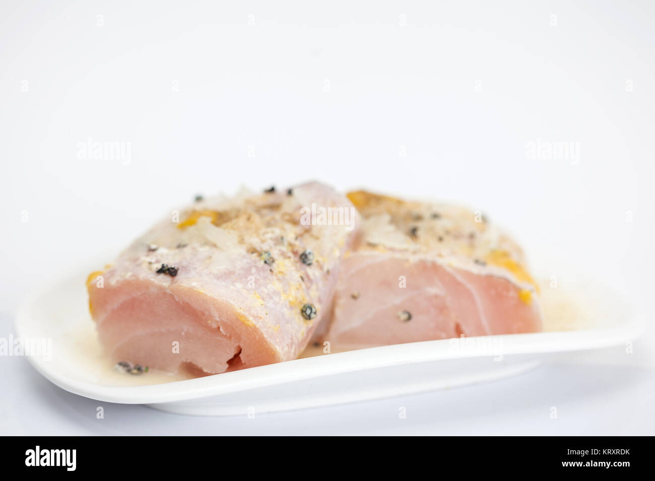 Fish fillet preparation : Marinated raw sea bass fillet Stock Photo - Alamy