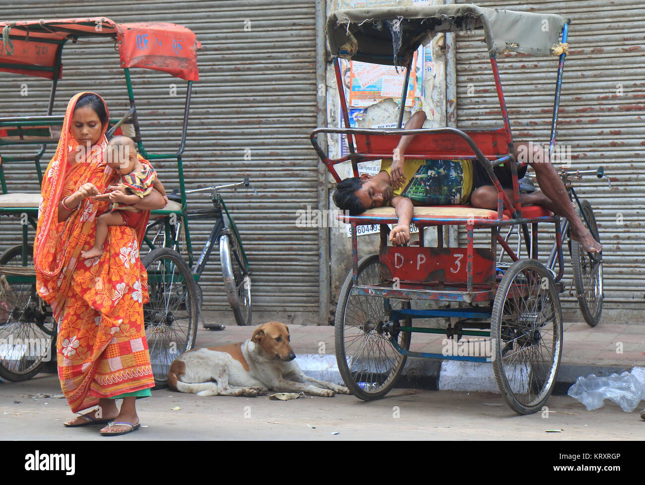 Local rickshaw driver sleeps in Esplande road Old Delhi India Stock ...
