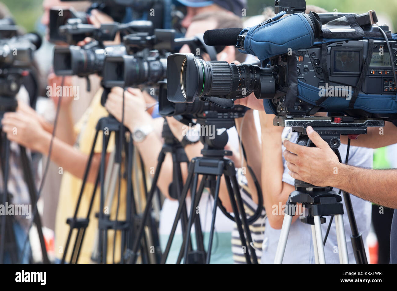 Video camera operators working at press conference Stock Photo - Alamy